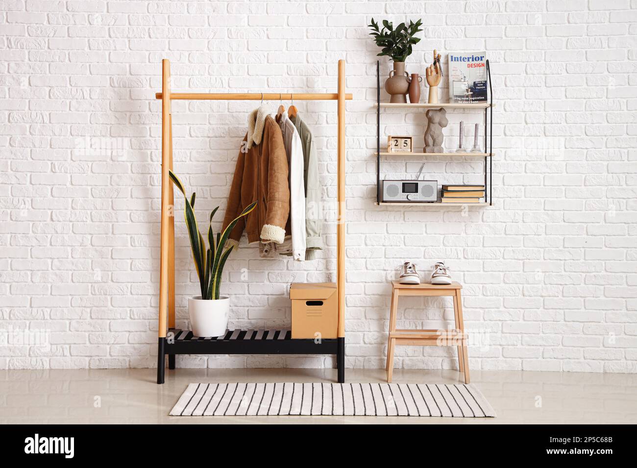 Interior of stylish hall with rack and shelf Stock Photo - Alamy