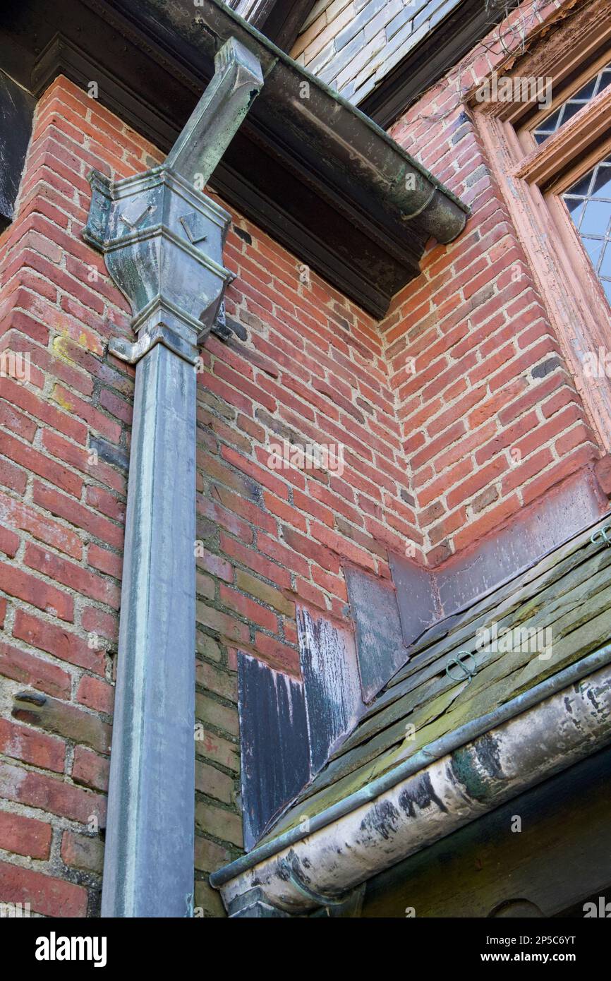 Old fashioned gutter system on abandoned, red brick building that is ...