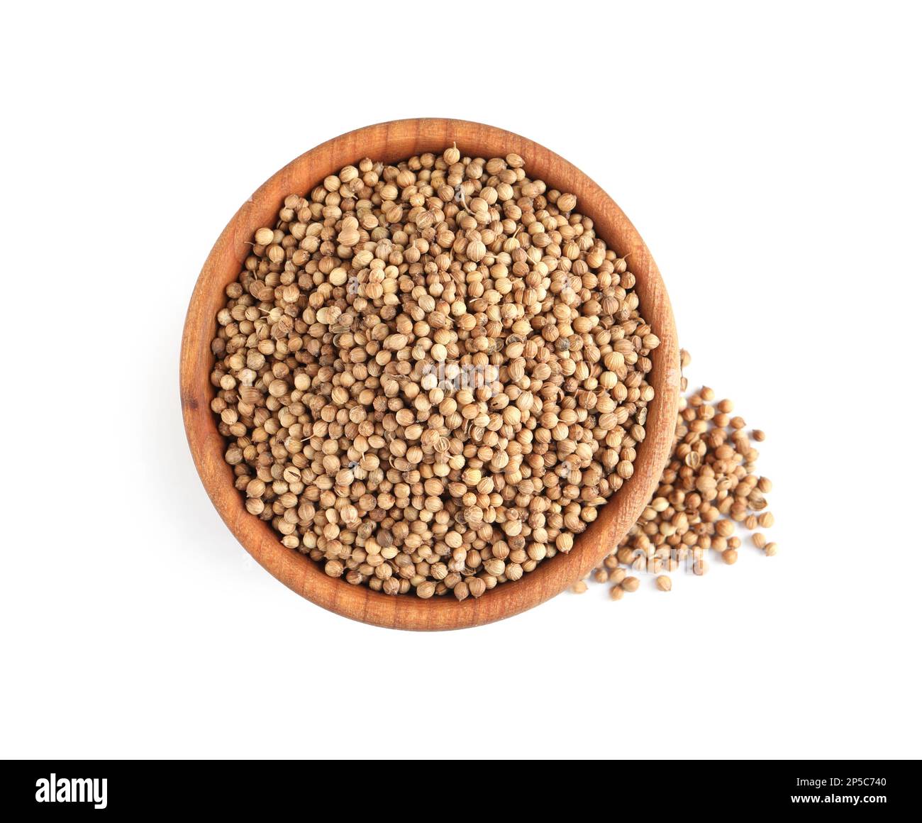 Dried coriander seeds in wooden bowl on white background, top view ...