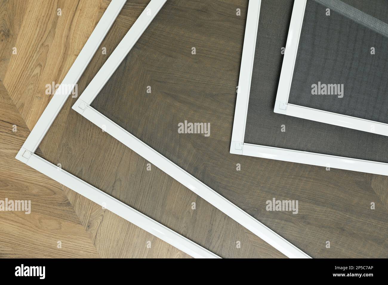 Set of window screens on wooden floor, flat lay Stock Photo - Alamy