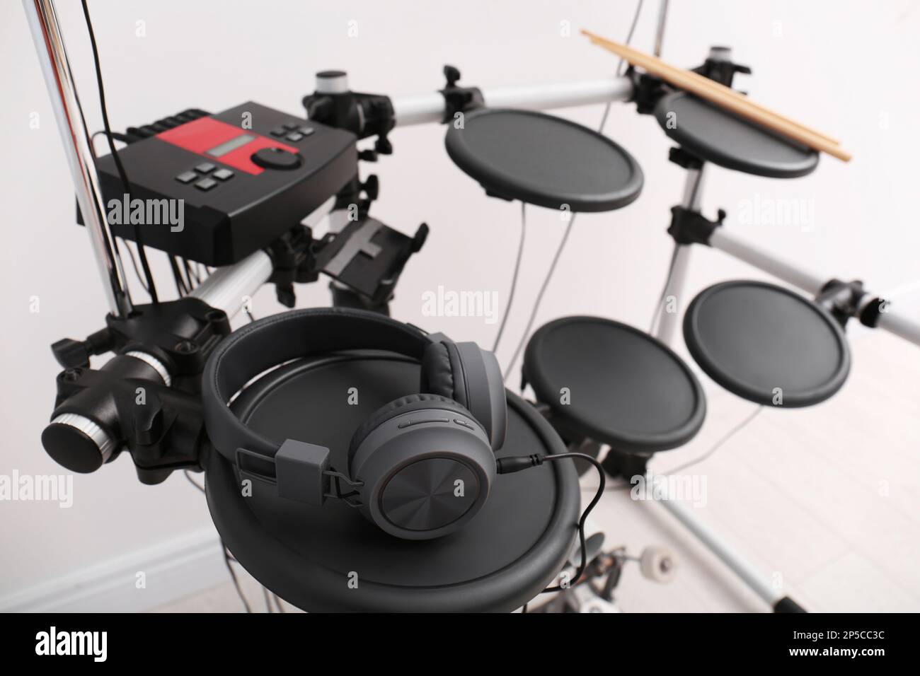 Modern electronic drum kit with headphones indoors. Musical instrument ...