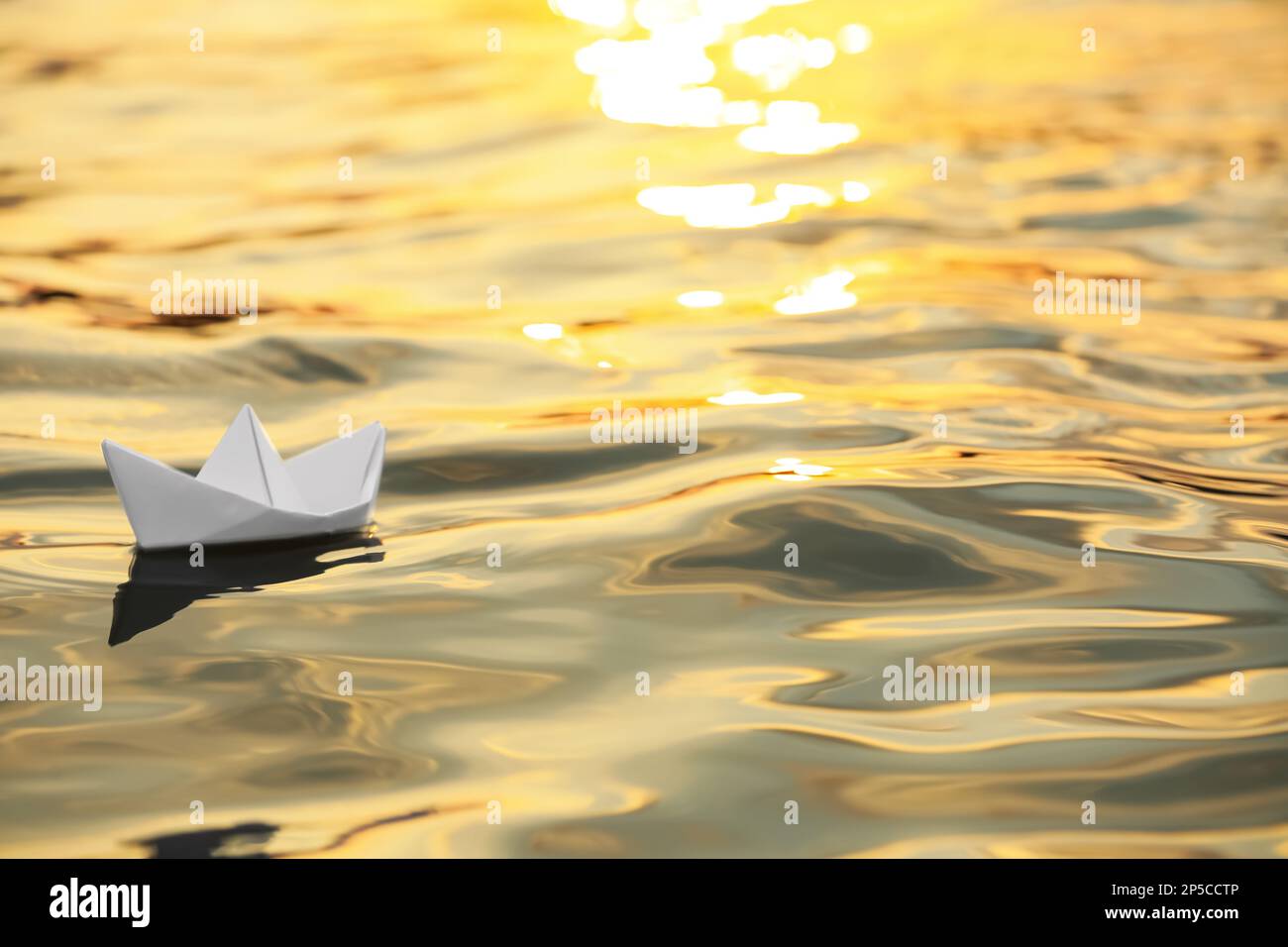 Paper boat floating on water outdoors. Space for text Stock Photo - Alamy