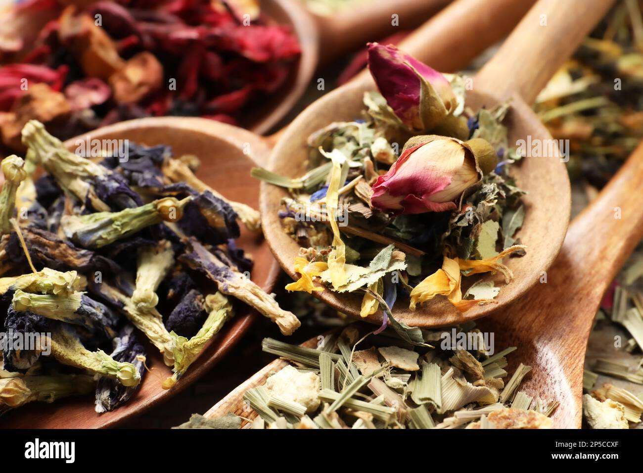 Wooden spoons with different teas on table, closeup Stock Photo - Alamy
