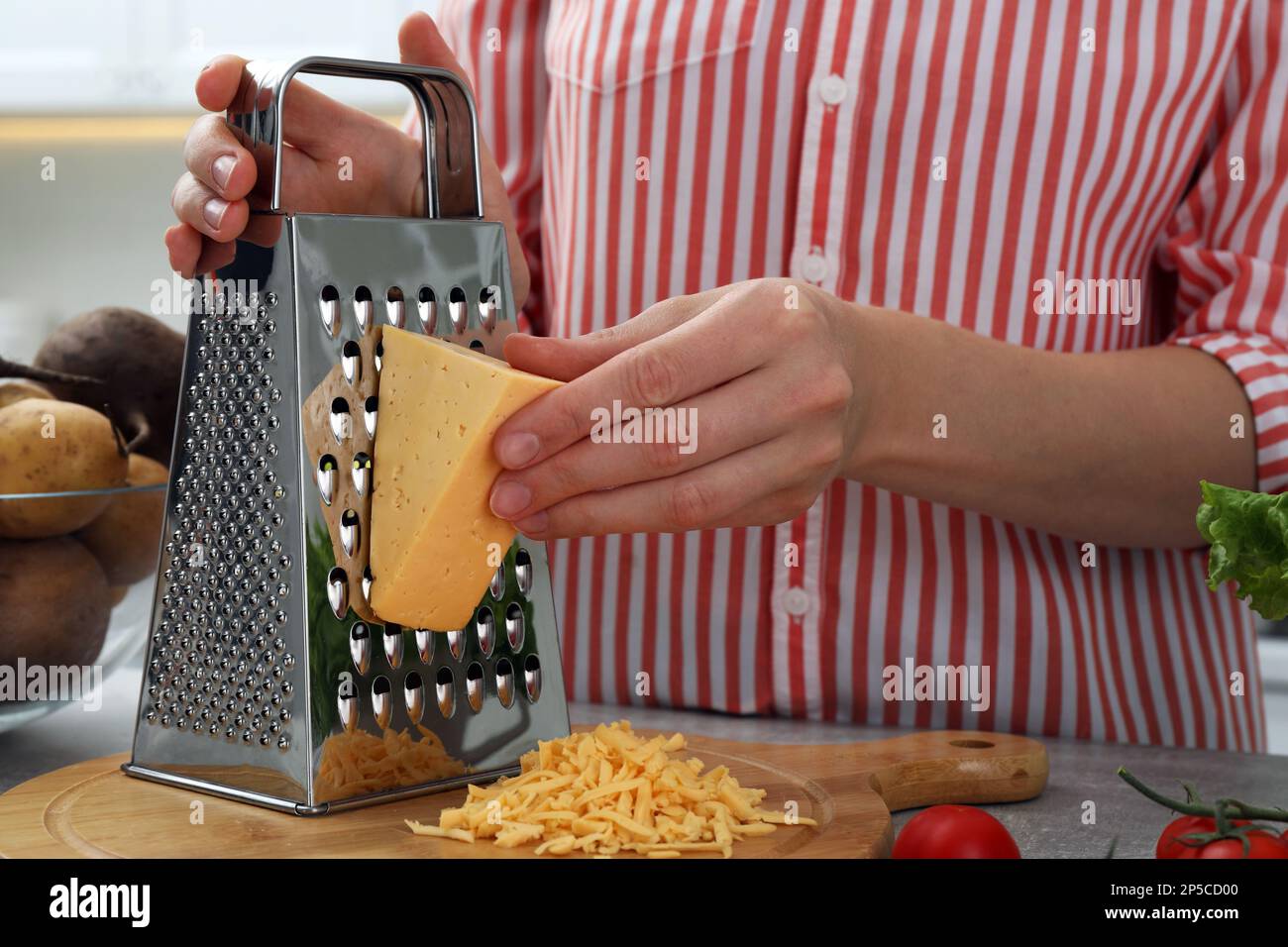 Grating cheese grater hands hi-res stock photography and images - Alamy