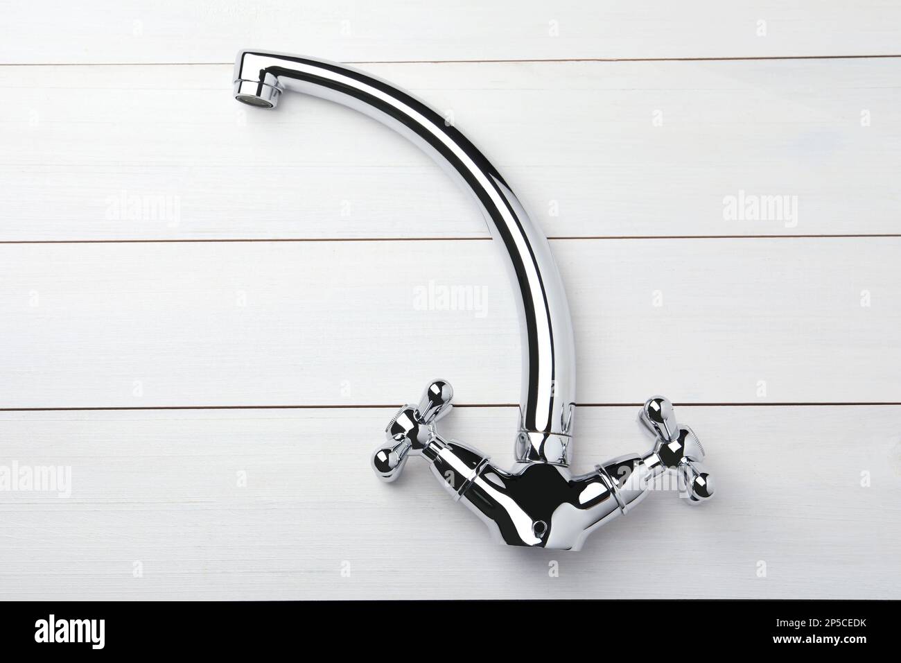 Double handle water tap on white wooden table, top view Stock Photo - Alamy