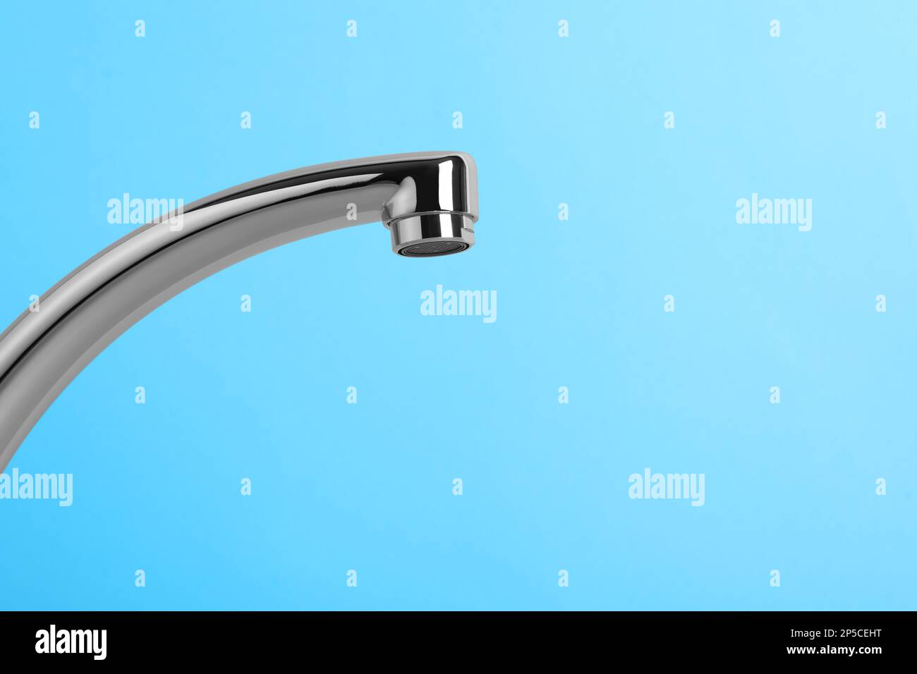 Modern water tap on light blue background, closeup. Space for text ...