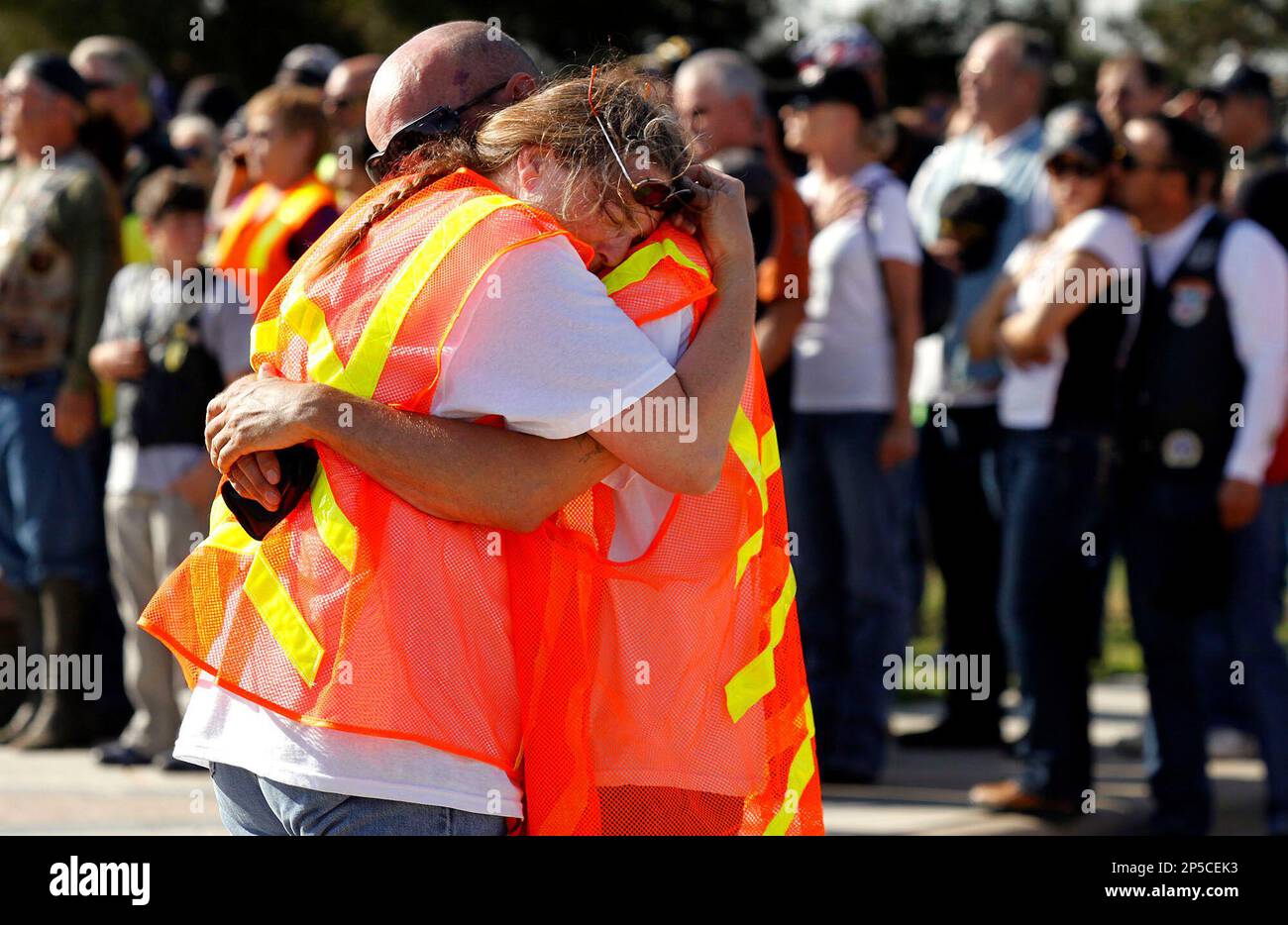 Navy Veteran Kathy Forkert cries on her husband Steve's shoulder while ...