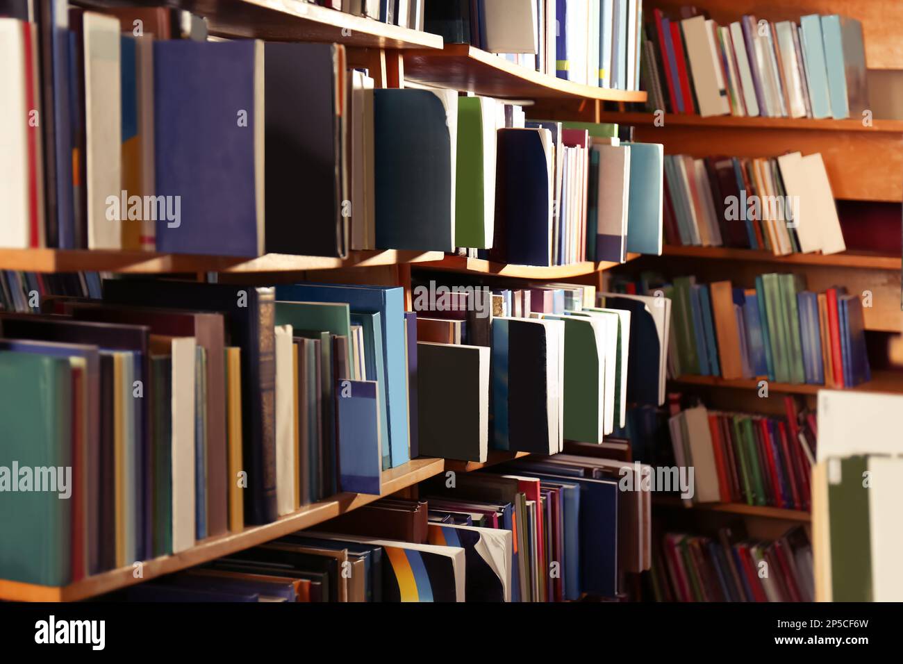 Collection of different books on shelves in library Stock Photo - Alamy