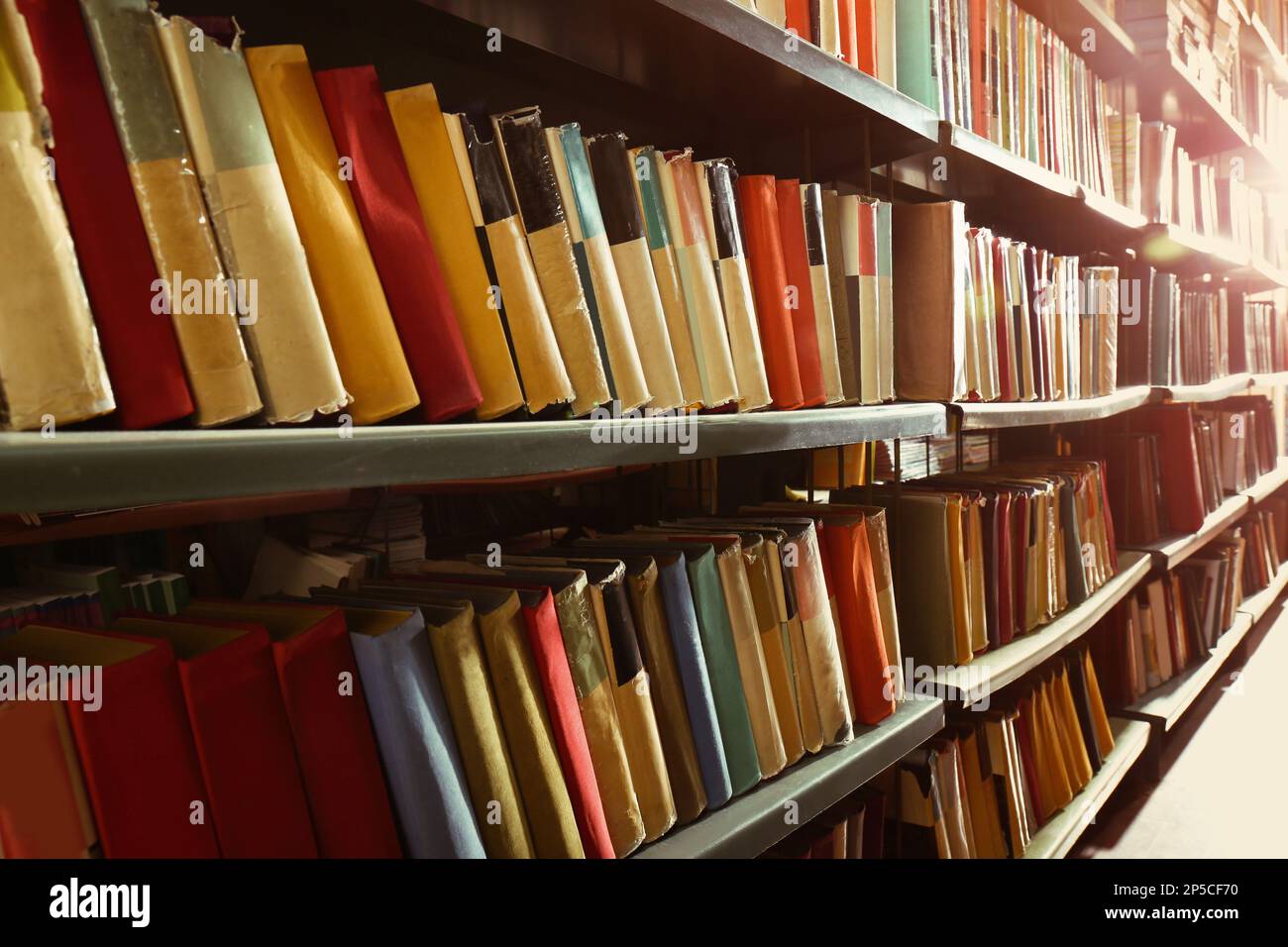 Collection of different books on shelves in library Stock Photo - Alamy