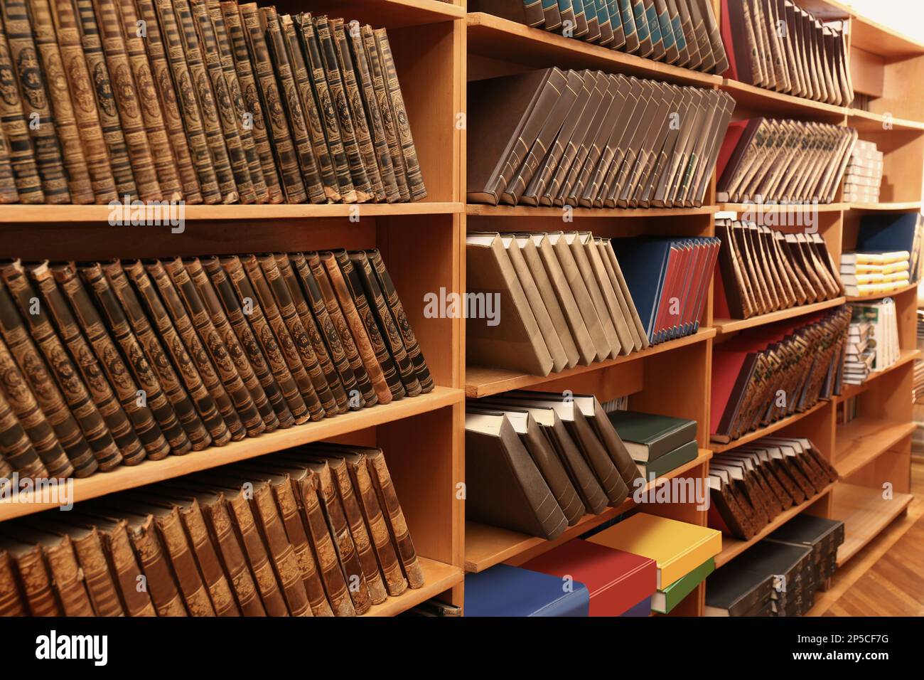 Collection of different books on shelves in library Stock Photo - Alamy