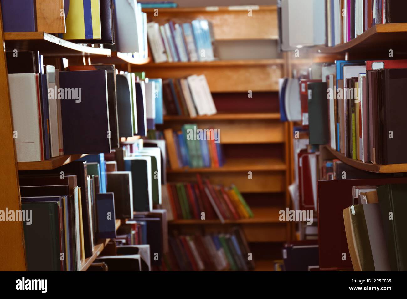 Collection of different books on shelves in library Stock Photo - Alamy