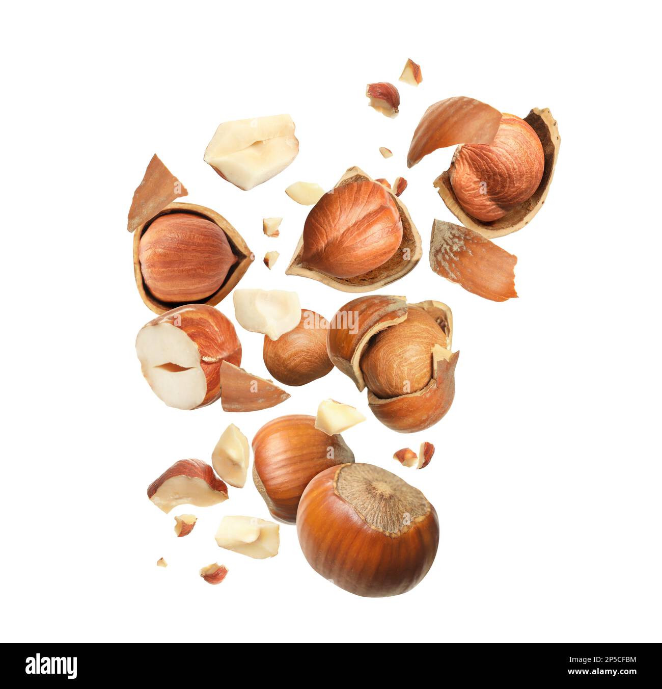 Pieces of tasty hazelnuts falling on white background Stock Photo - Alamy