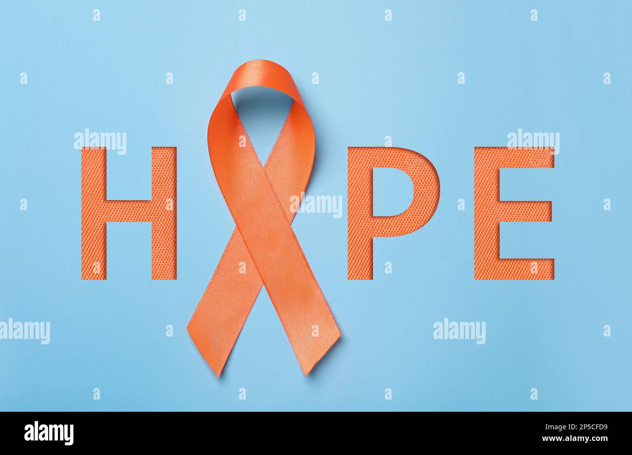 Orange awareness ribbon and word HOPE on light blue background, top ...