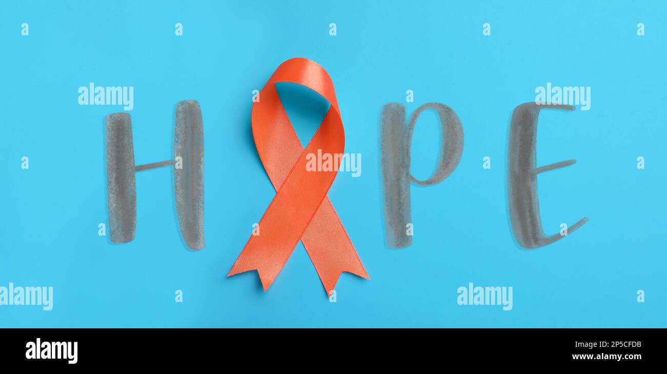Orange awareness ribbon and word HOPE on light blue background, top ...