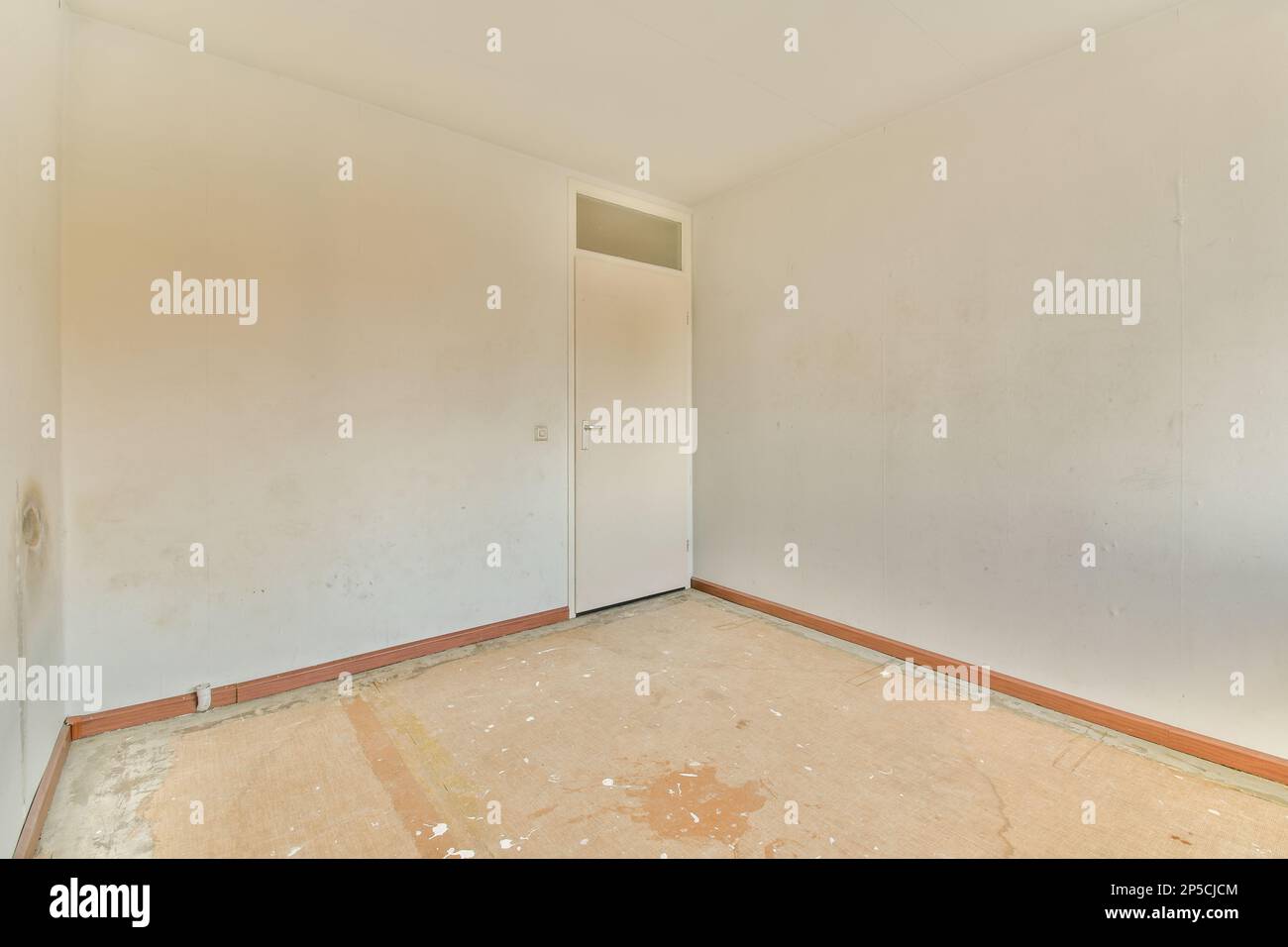 an empty room with white walls and peeling paint on the floor in this ...