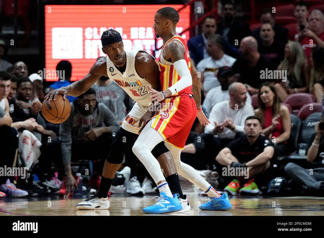 Miami Heat forward Jimmy Butler (22) looks for an open teammate past Atlanta Hawks guard ...