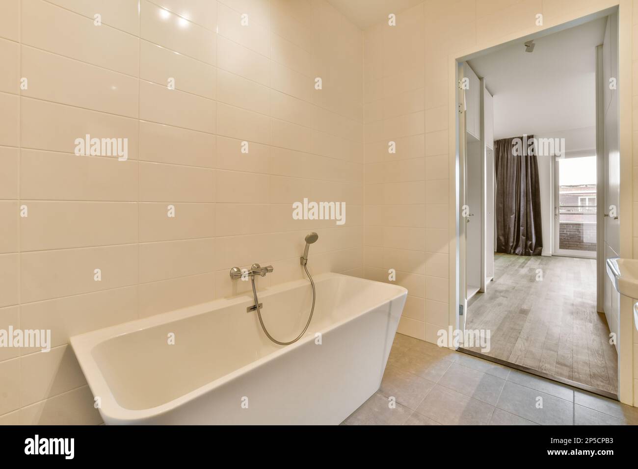 a bathroom with a bathtub and toilet in the fore - image is taken from ...