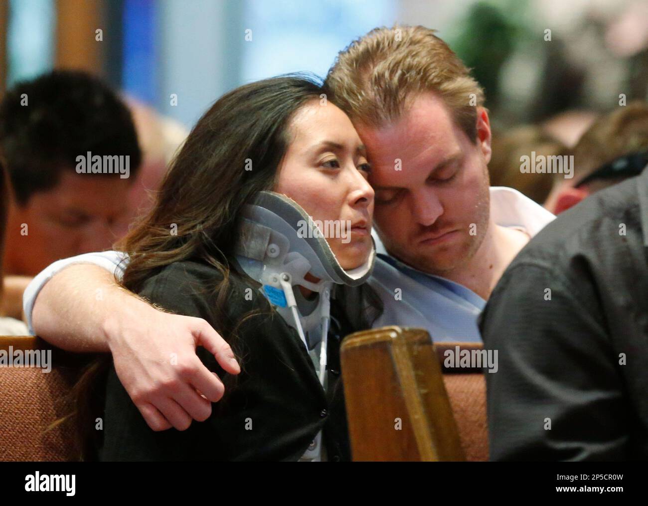Jennifer Doan, left, is embraced by her fiance, Nyle Rogers, right ...