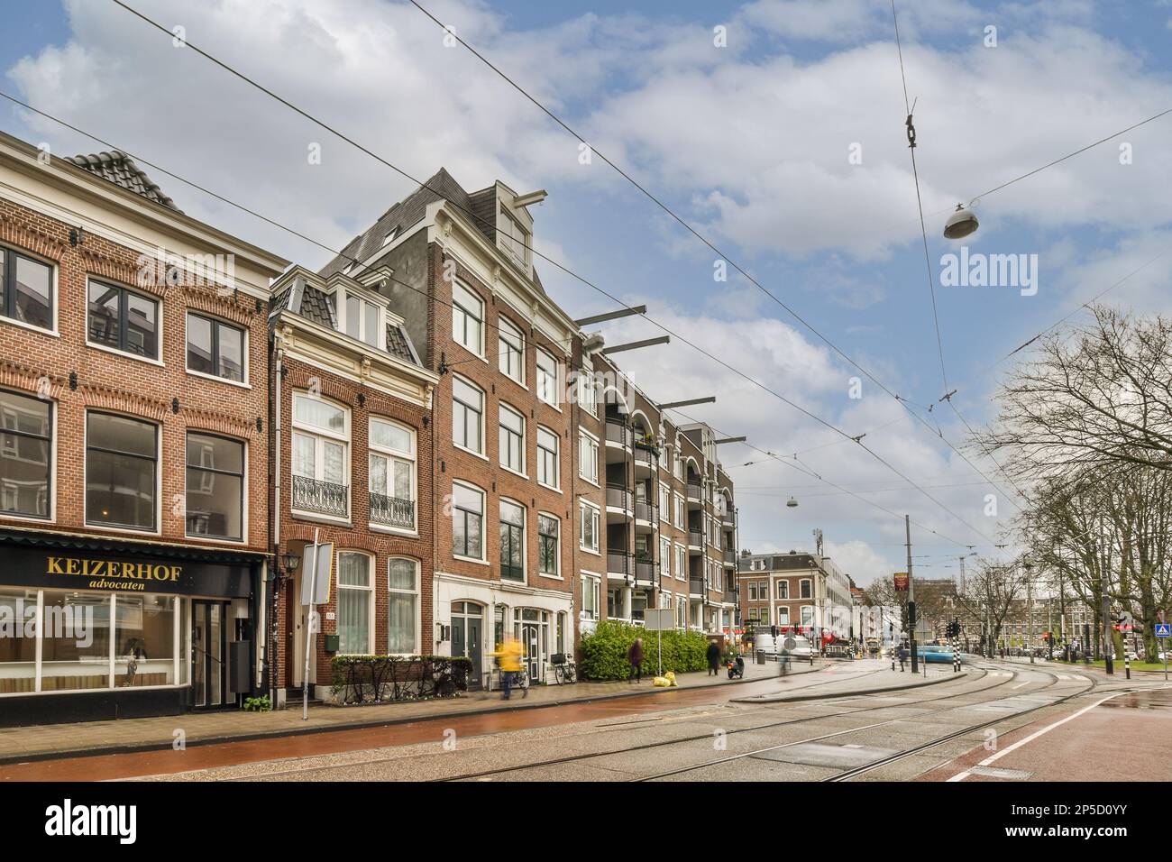 an empty street in the middle of a city with buildings on both sides ...
