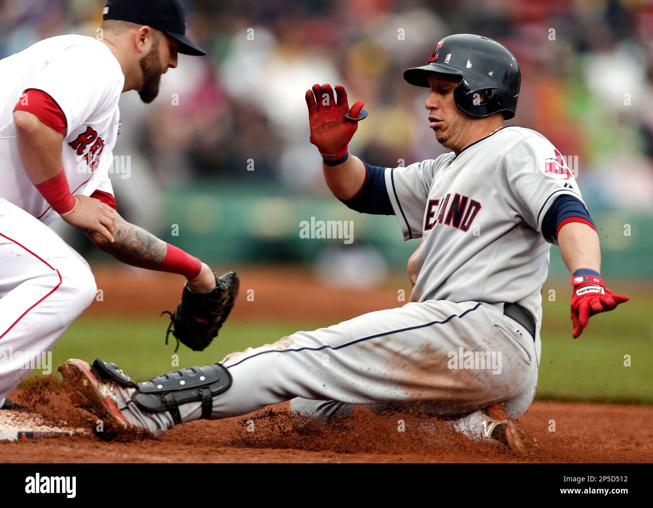 Cleveland Indians' Asdrubal Cabrera, right, slides safely back to first ...
