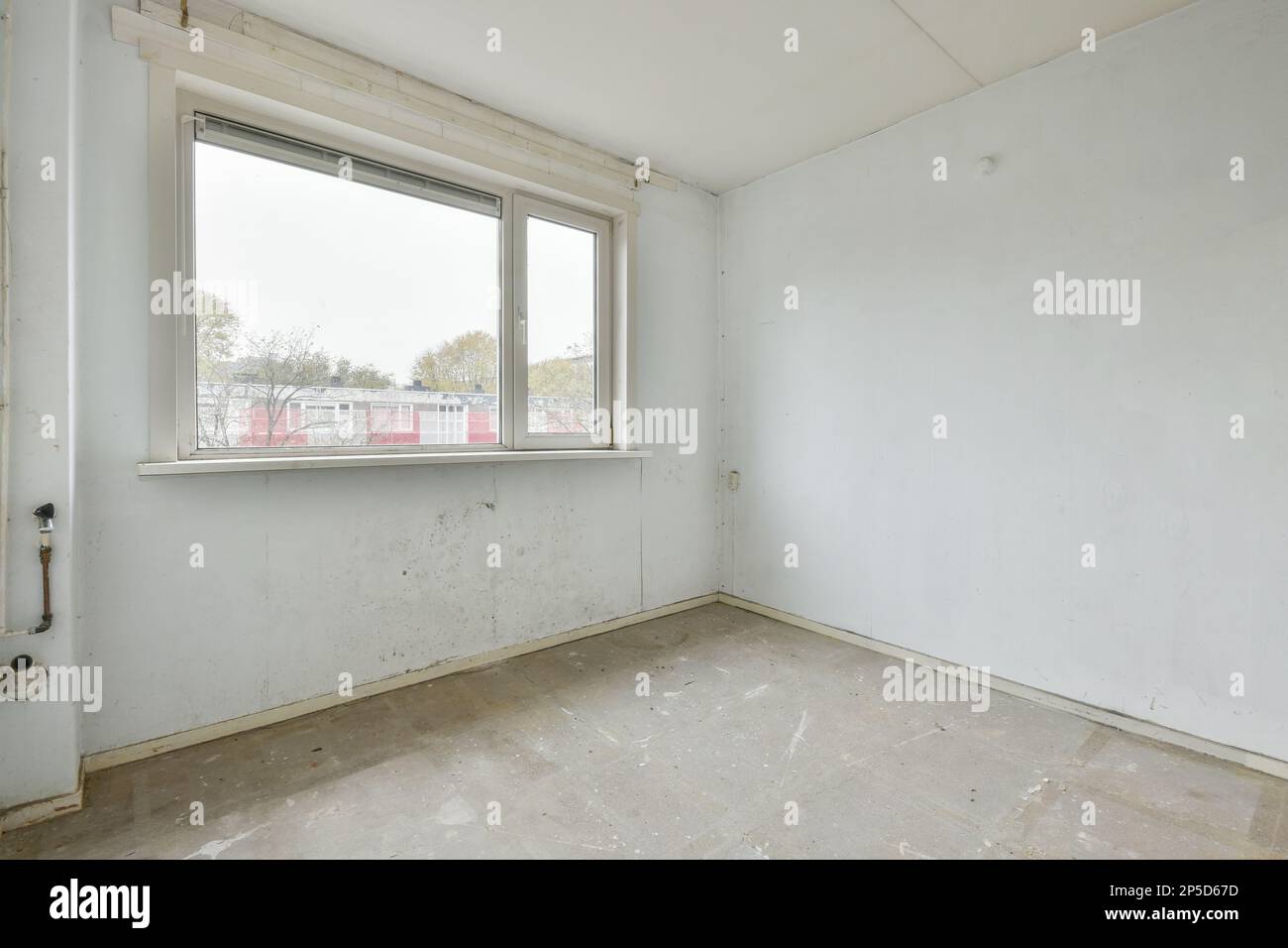 an empty room with white walls and no one window in the photo is taken ...