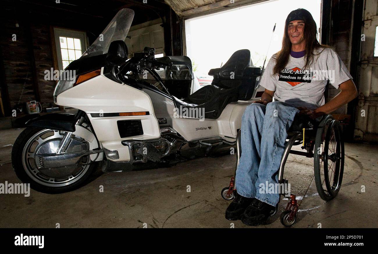 Travis Mundy, who is pretty much paralyzed from the waist down from an ...