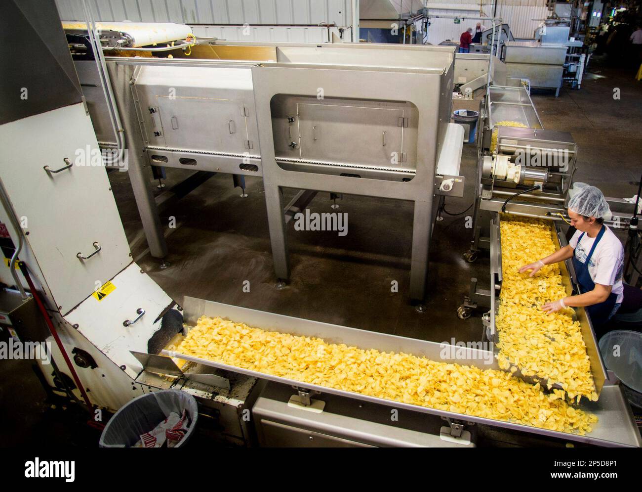 Production worker Sarah Gibson checks for quality as freshly cooked ...
