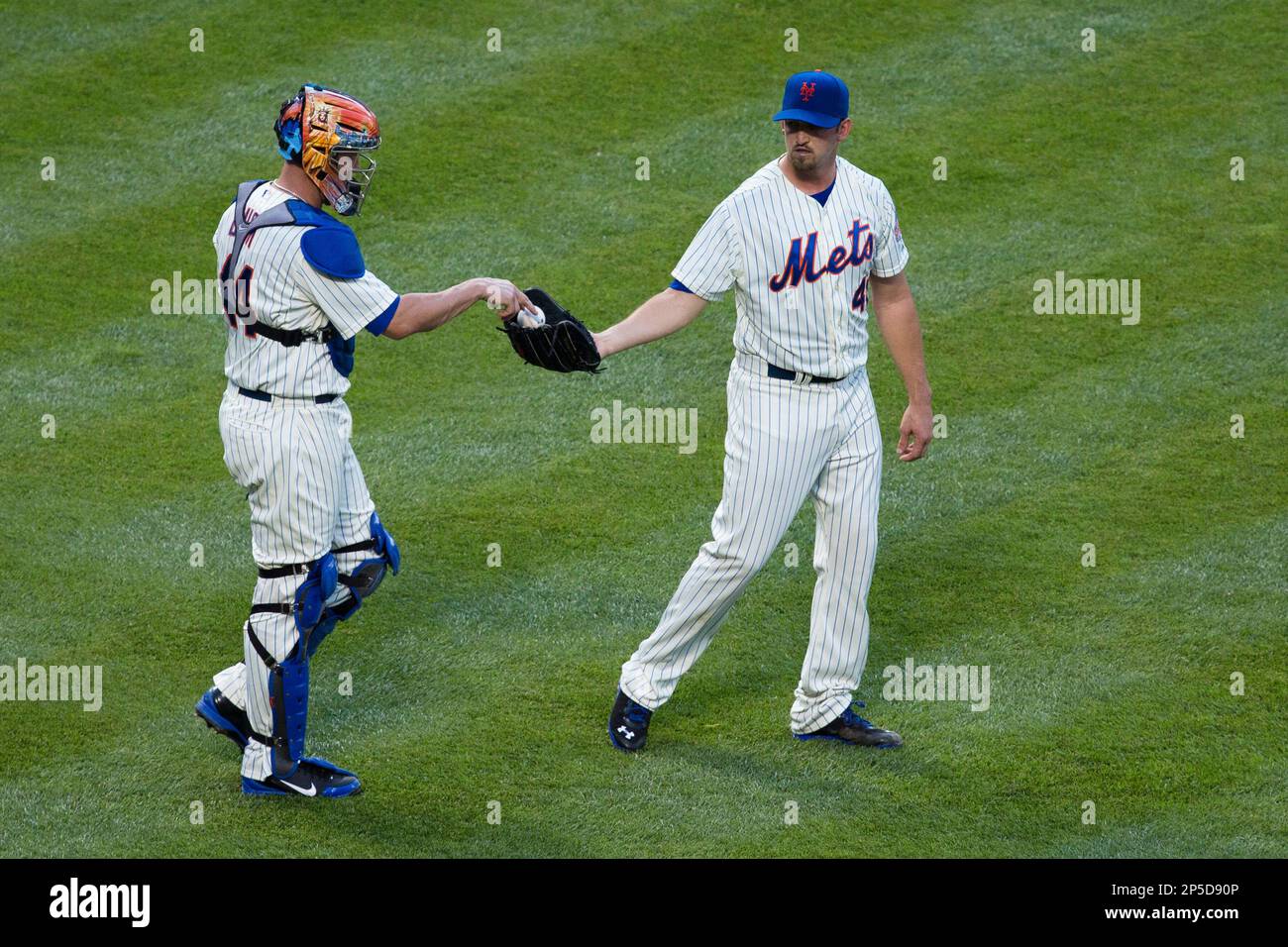 New York Mets catcher John Buck hands off the ball to starting pitcher ...