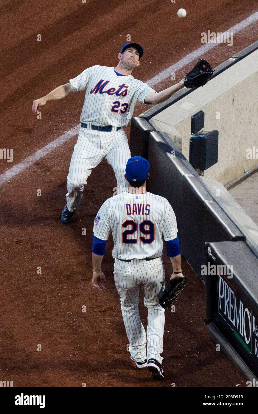 New York Mets right fielder Mike Baxter reaches for a foul ball during ...