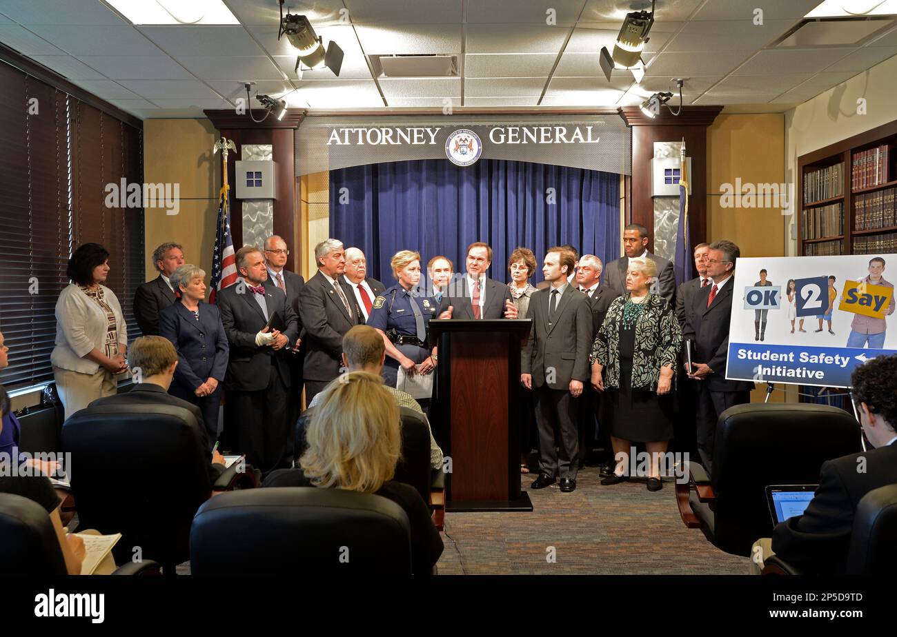 Attorney Gen. Bill Schuette is flanked by Lt. Gov. Brian Calley and MSP ...