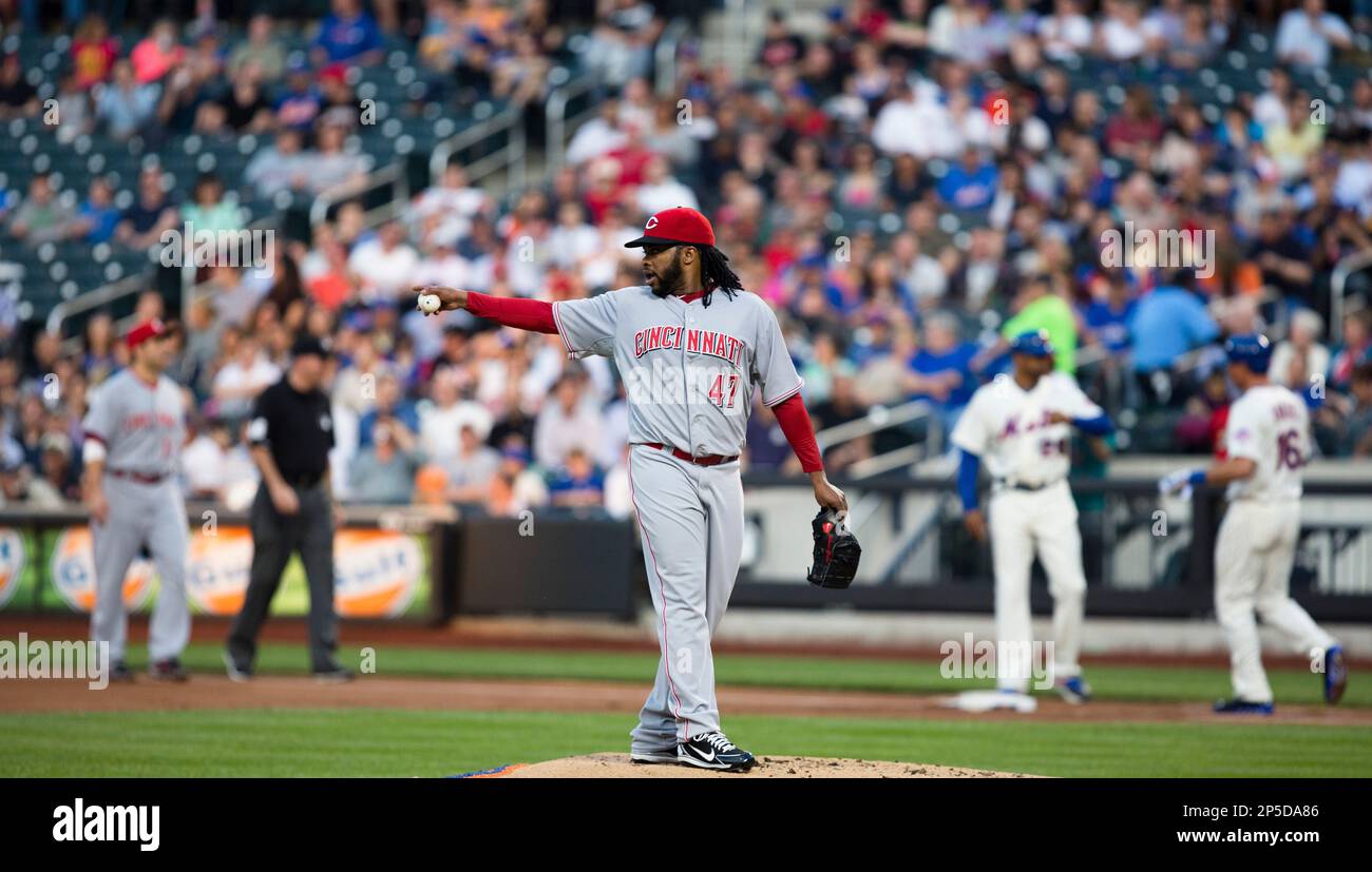 Cincinnati Reds starting pitcher Johnny Cueto signals to his teammates ...