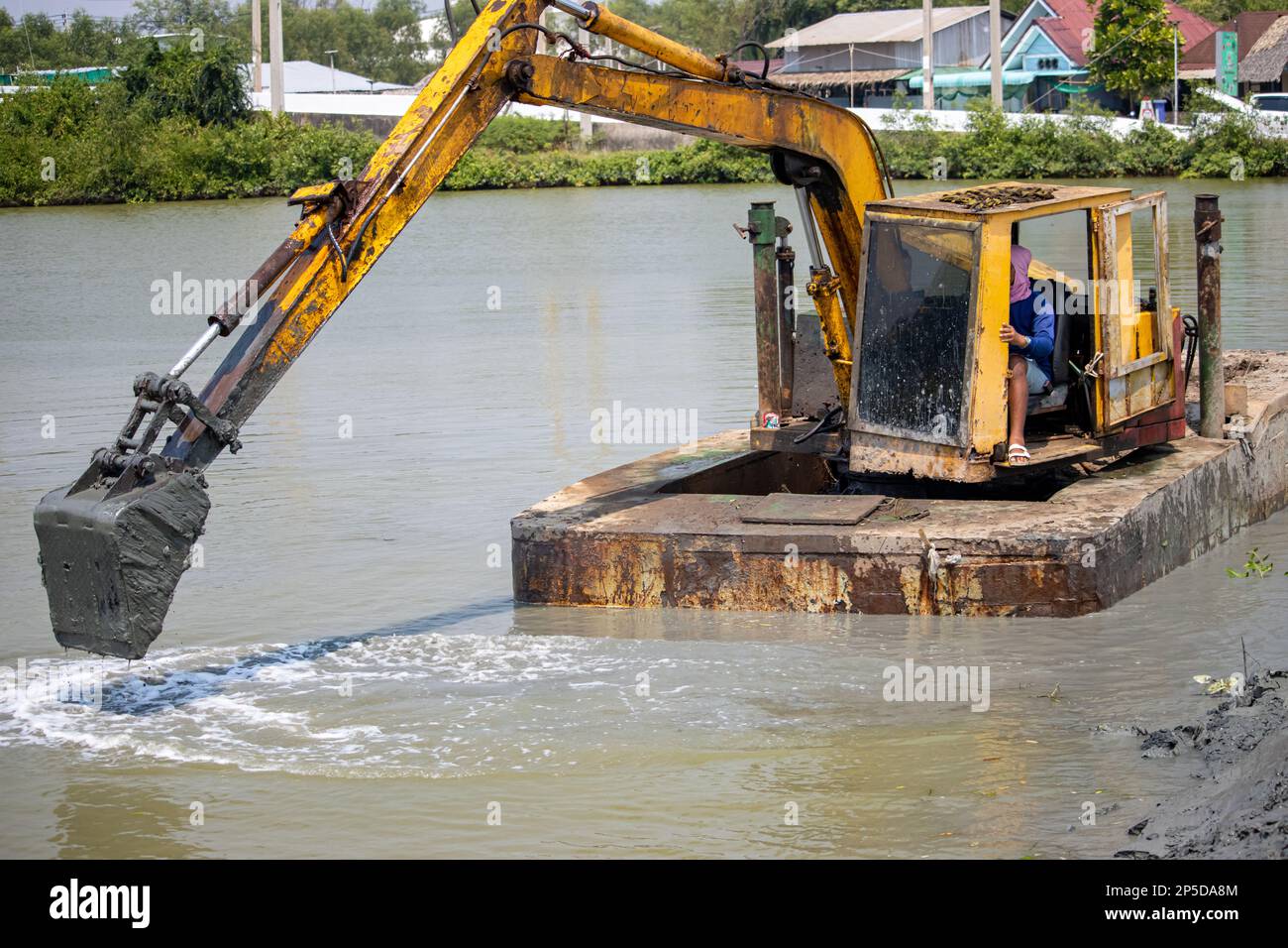A floating dredger is dredging the bottom of the pond, Thailand Stock ...