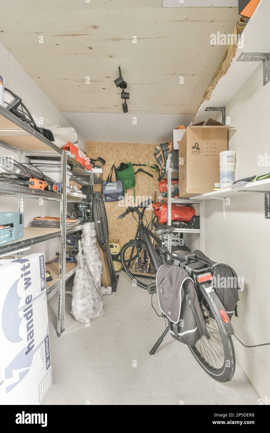 the inside of a garage with bikes and boxes on the floor in front of ...