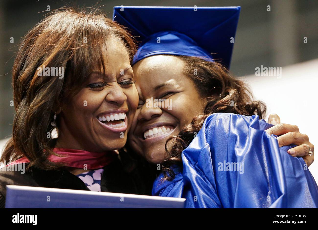 First lady Michelle Obama hugs Jenika Headley-Greene as Obama hands out ...
