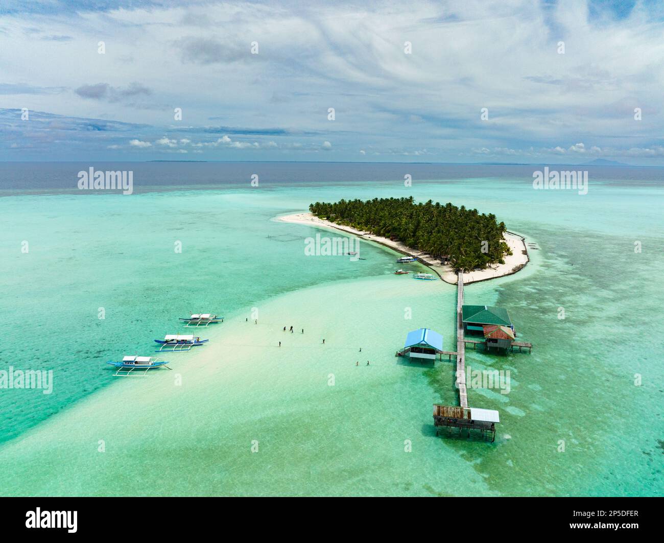 Aerial view of tropical island on an atoll with a beautiful beach. Onok ...