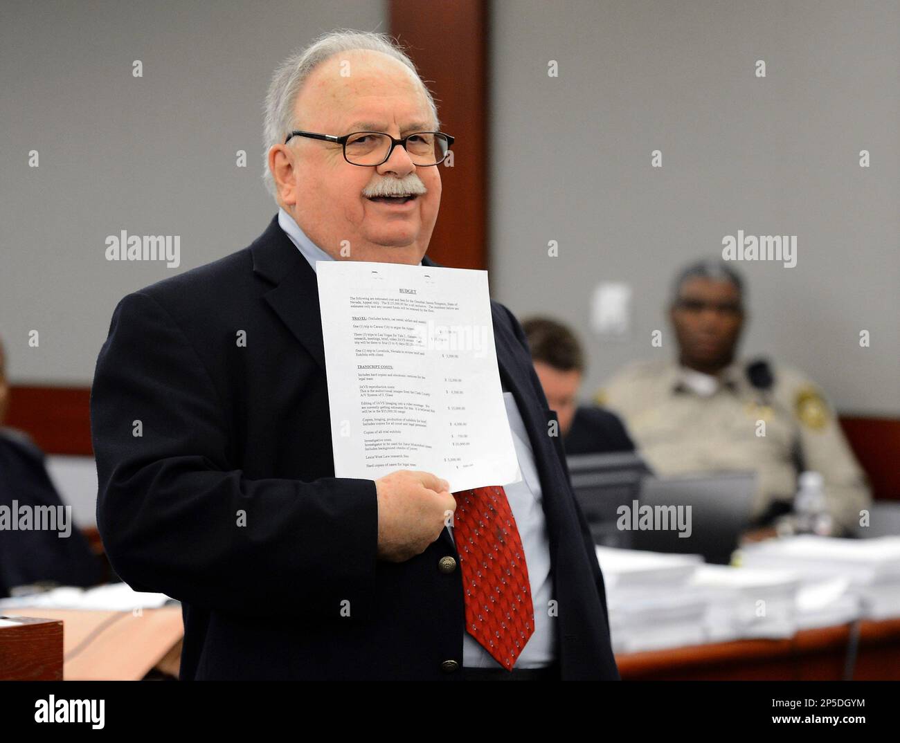 O.J. Simpson's lawyer Tom Pitaro holds up a copy of a defense budget ...