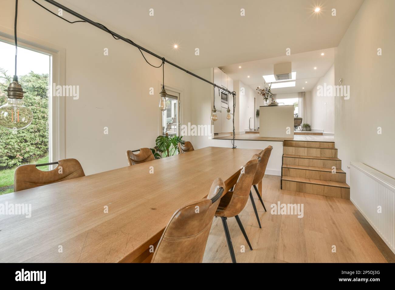 a dining table and chairs in a room with an open window looking out ...