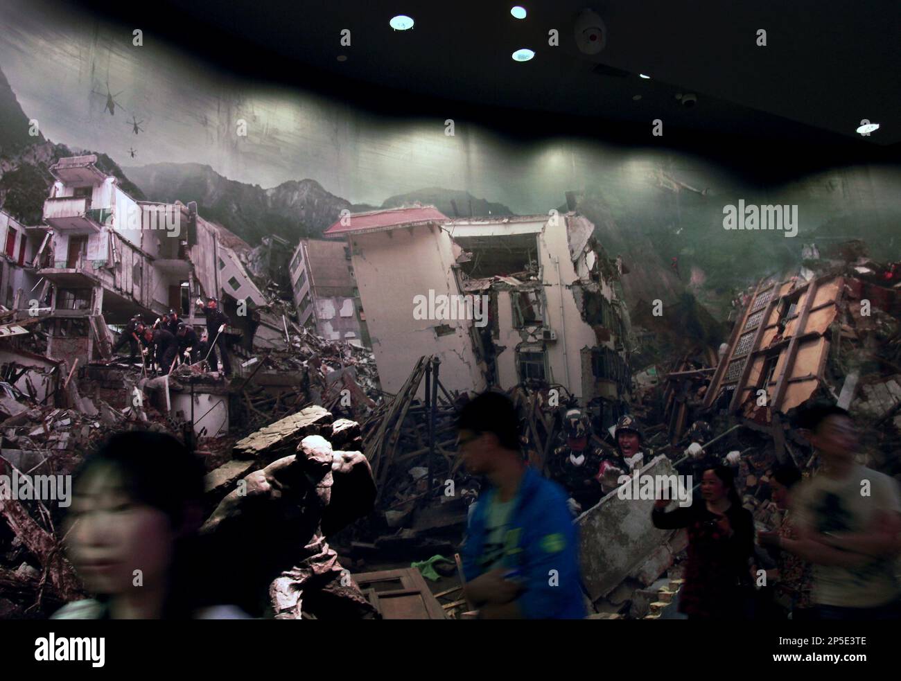 Visitors walk past pictures of 2008 Sichuan earthquake scenes on ...