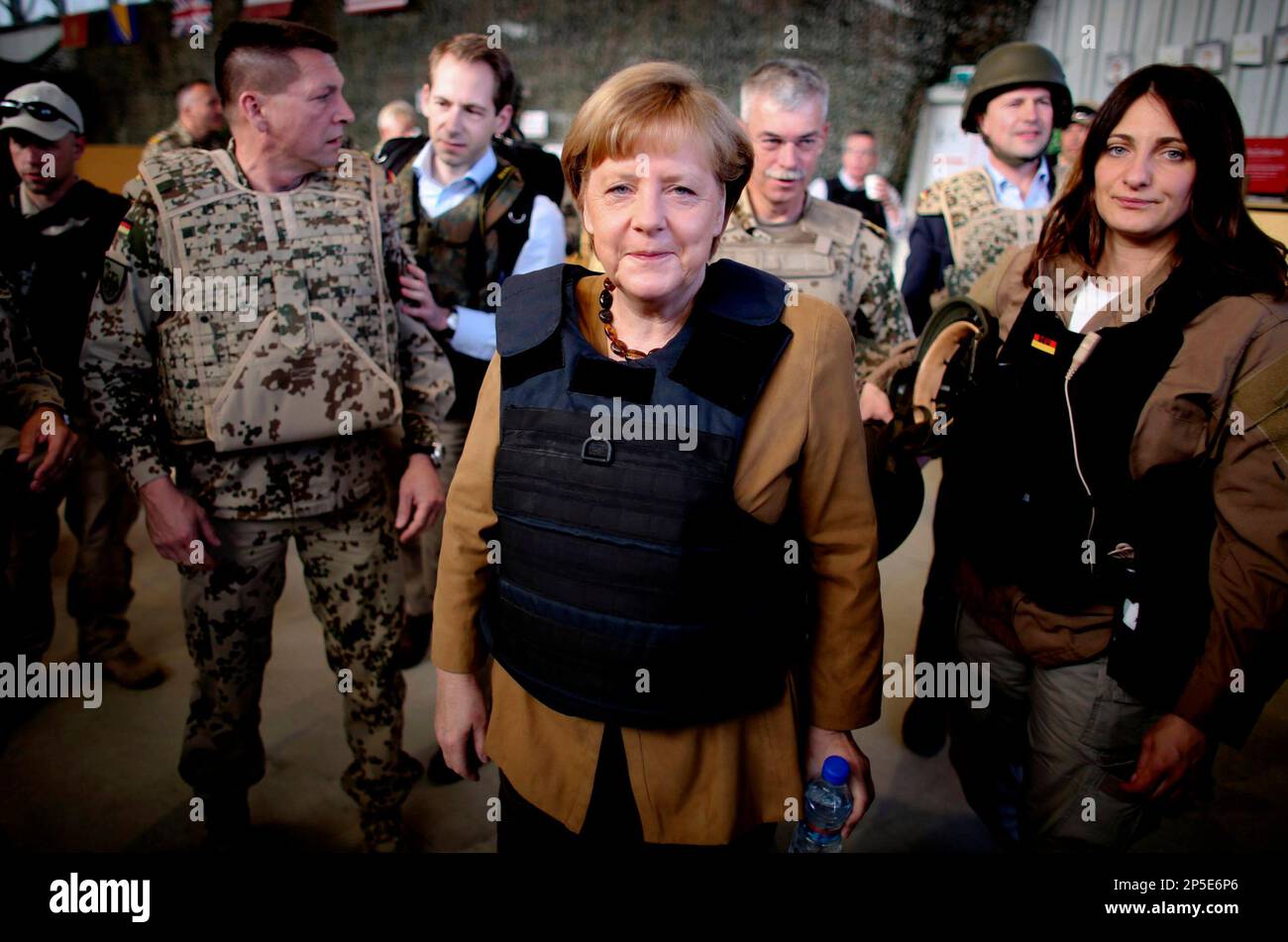 German Chancellor Angela Merkel, center, is dressed in a bullet proofed ...