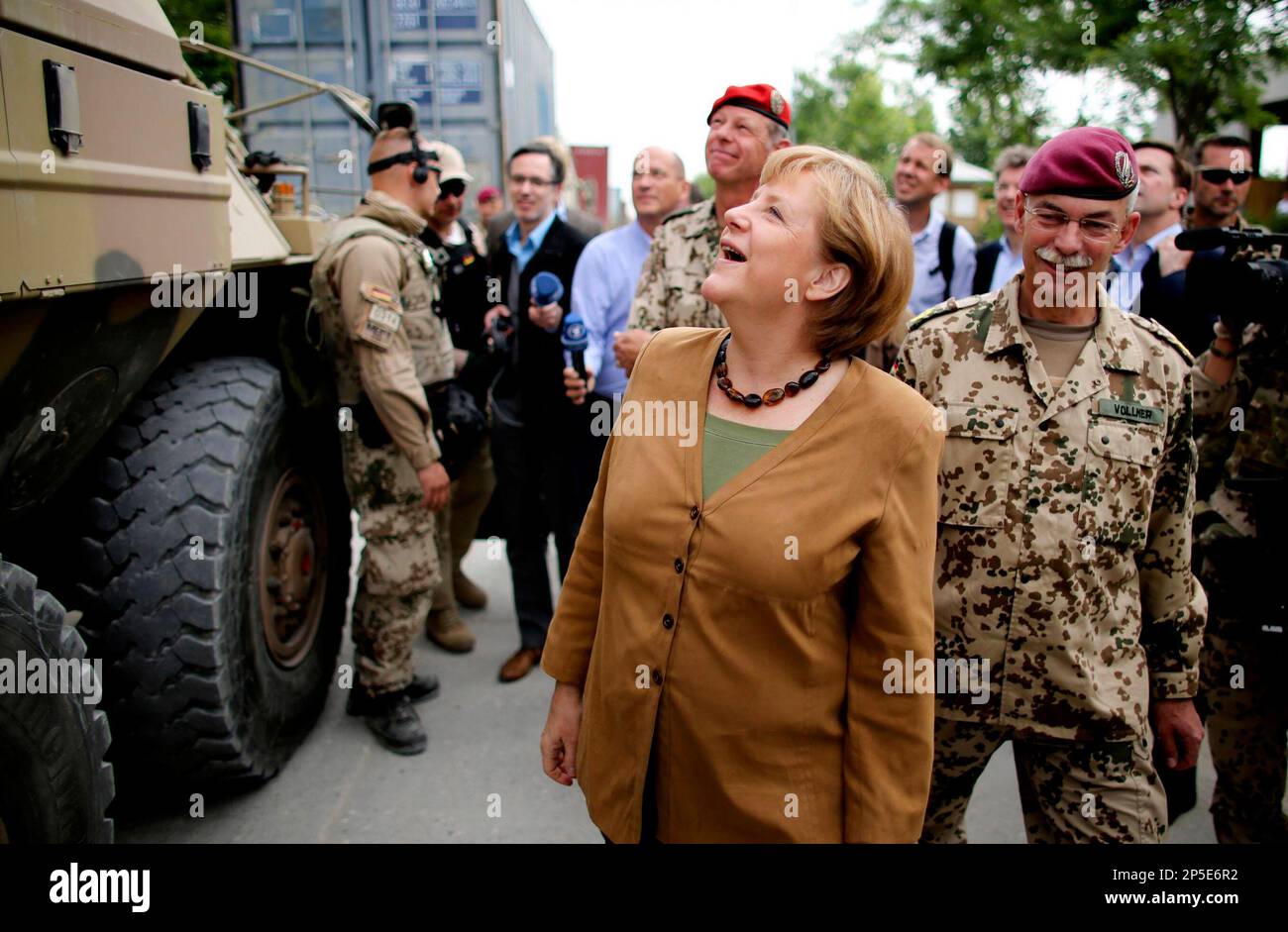 German Chancellor Angela Merkel, center, and German Major General Joerg ...