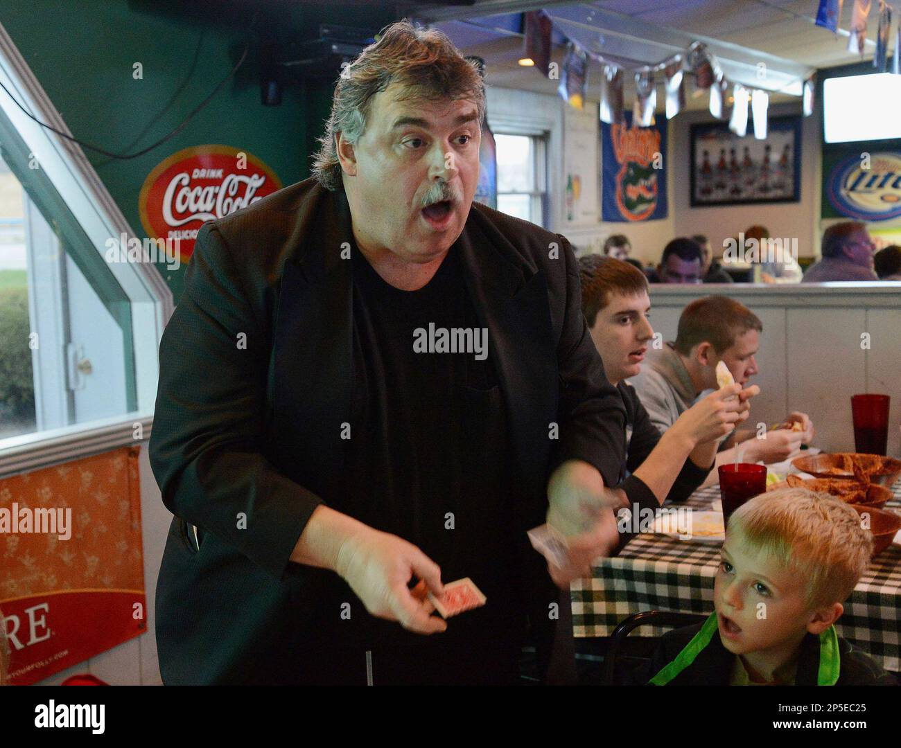In this April 12, 2013 photo, magician Mark Doetsch performs for ...