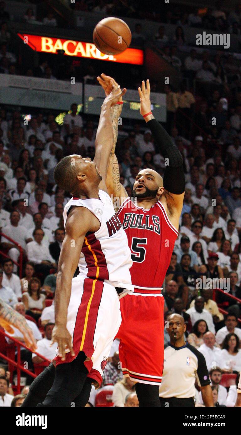 Miami Heat forward Chris Bosh, left, tries to block a shot by Chicago ...