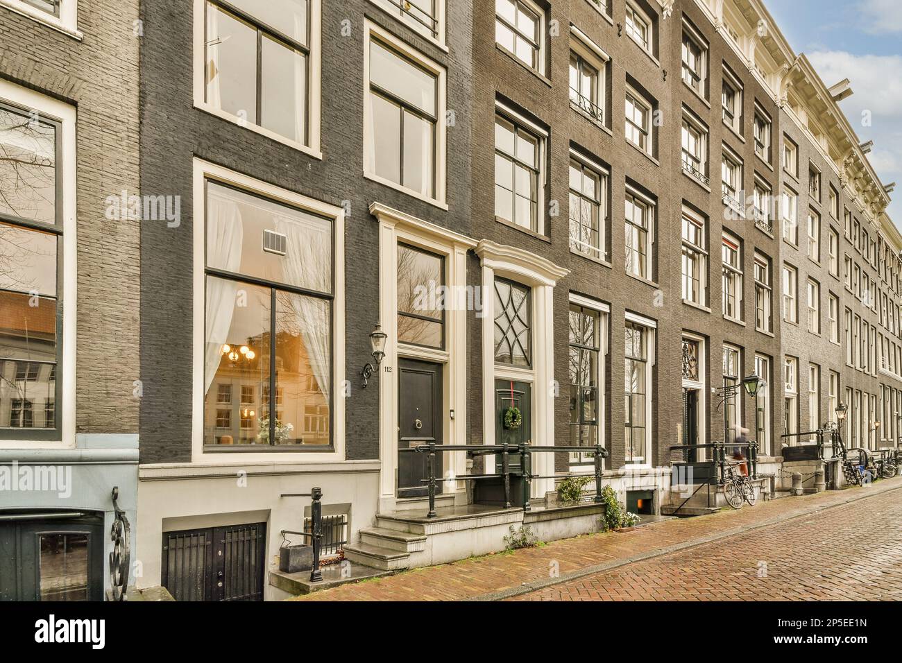 a city street with buildings on both sides and people walking down the ...