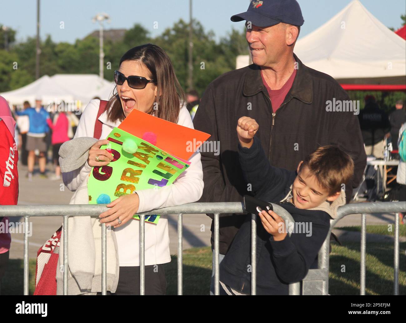Kelly Sallee, cheers for her husband, Brian, with her son Colby after ...