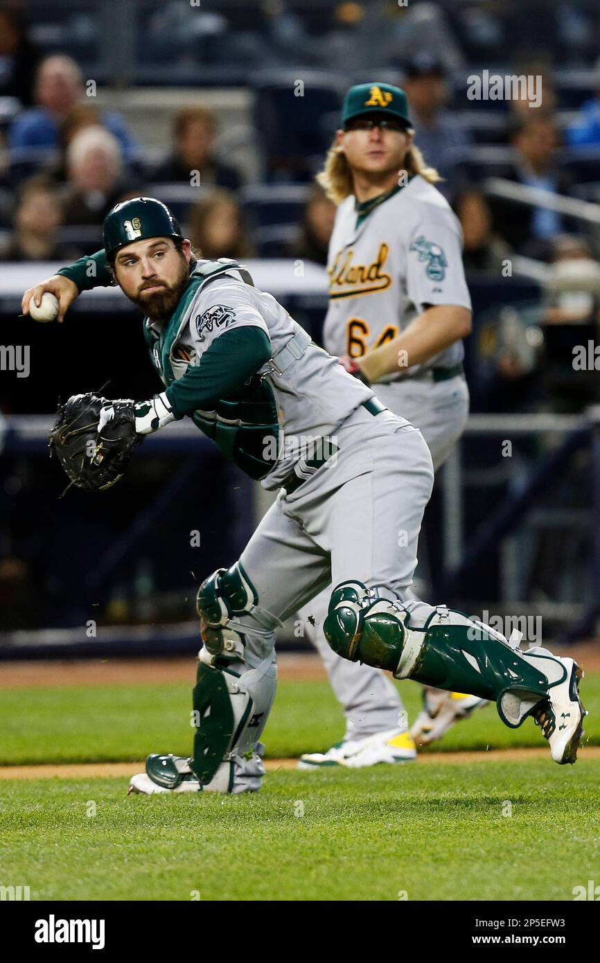 Oakland Athletics catcher Derek Norris throws the ball towards first ...