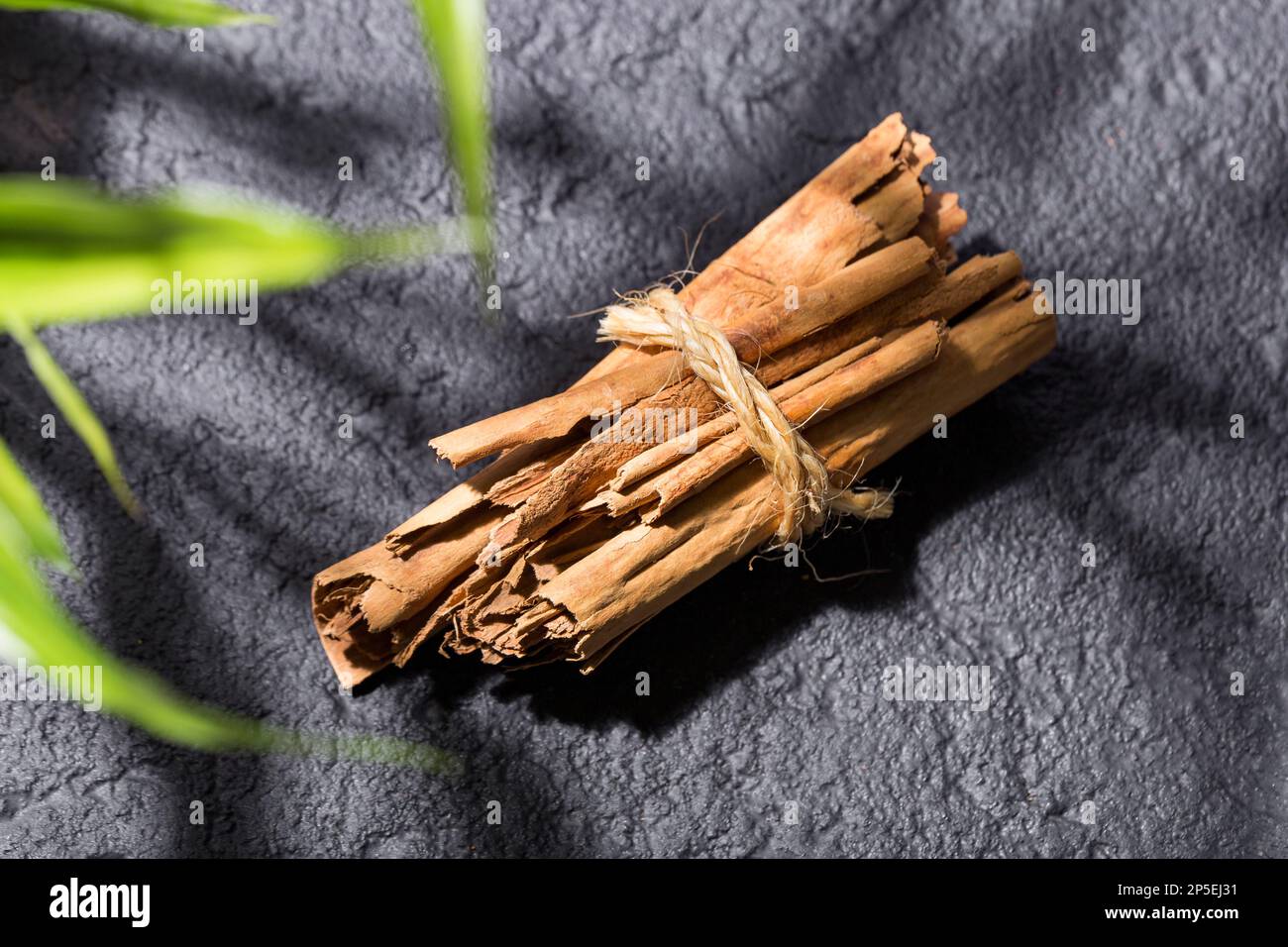 Rustic comfort - cinnamon sticks on black background with natural ...