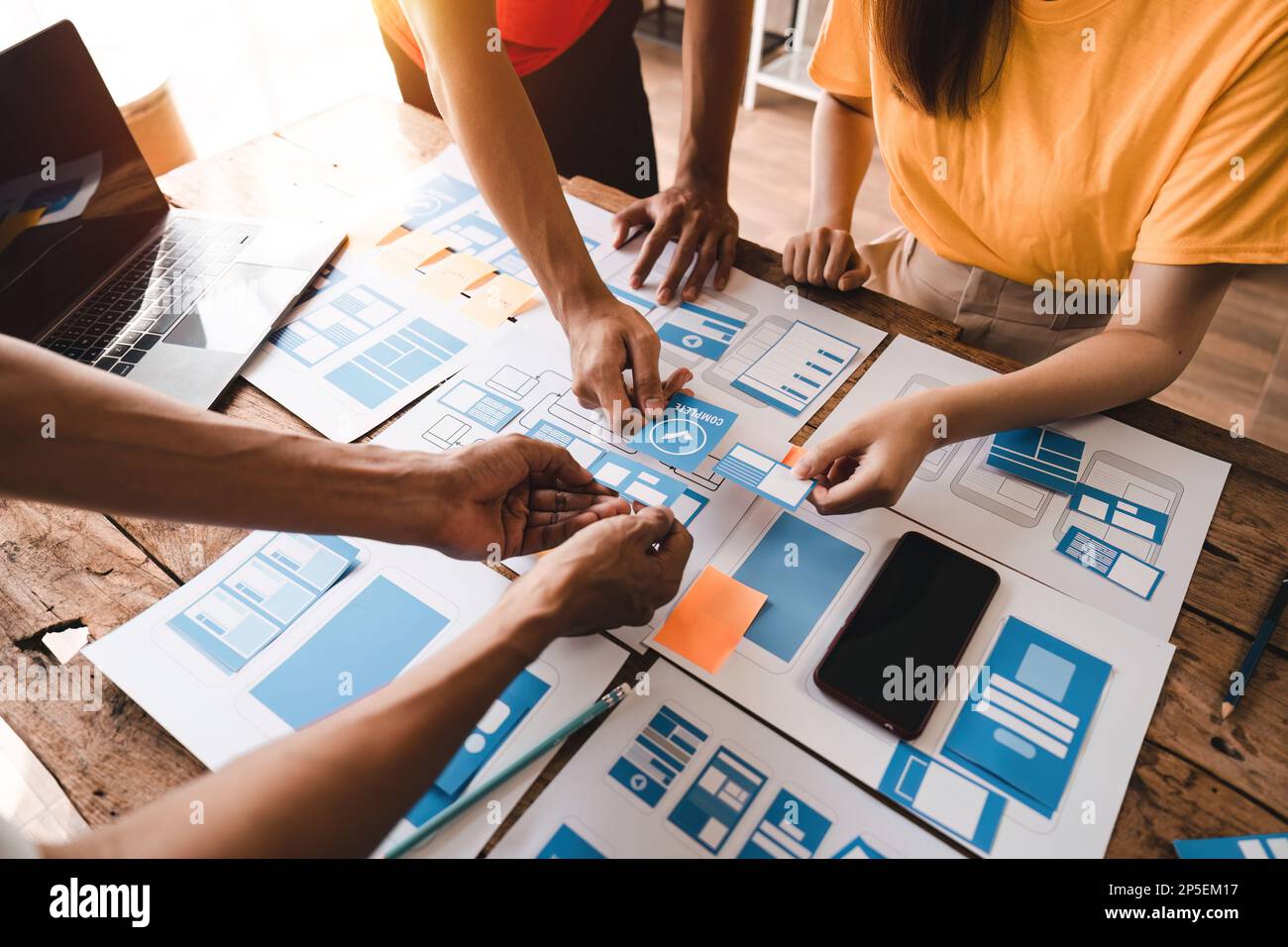 Close up ux developer and ui designer brainstorming about mobile app ...