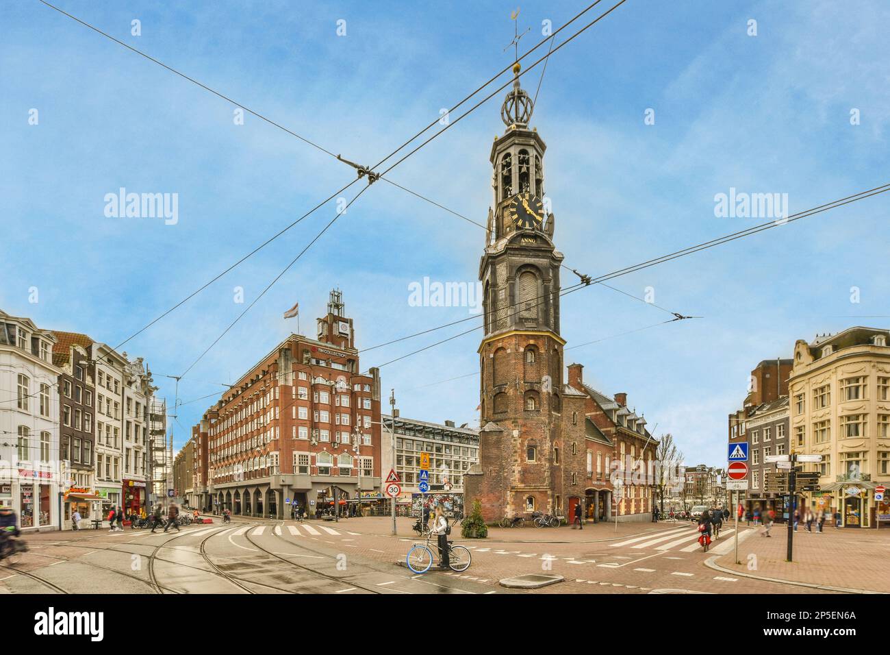a clock tower in the middle of an intersection with cars and people ...