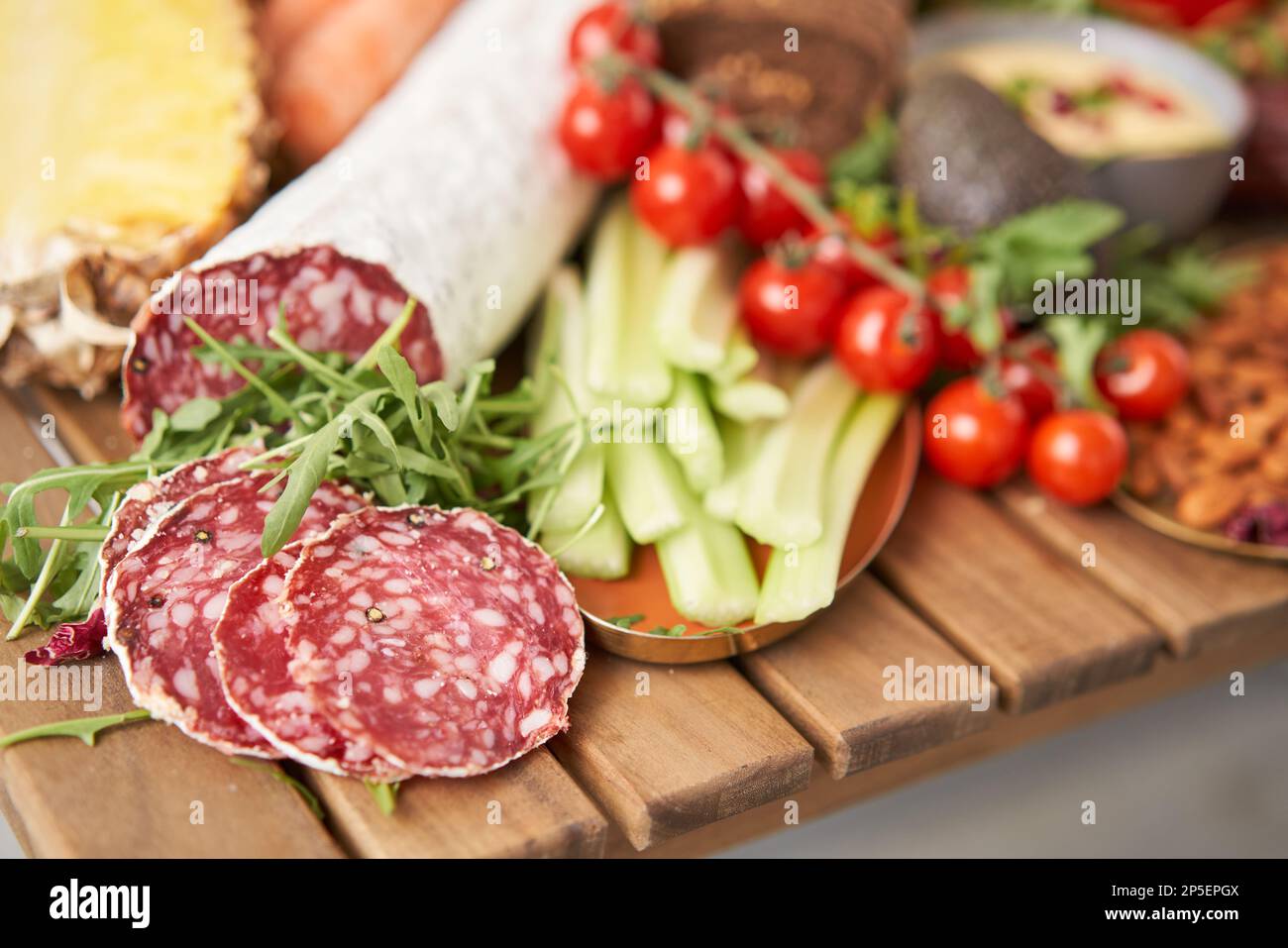 Salami sausage close-up. Table full of mediterranean appetizers, tapas ...
