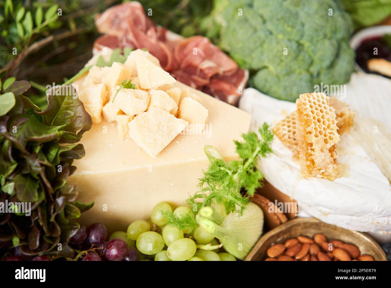 Parmesan cheese with honey close-up. Table full of mediterranean ...